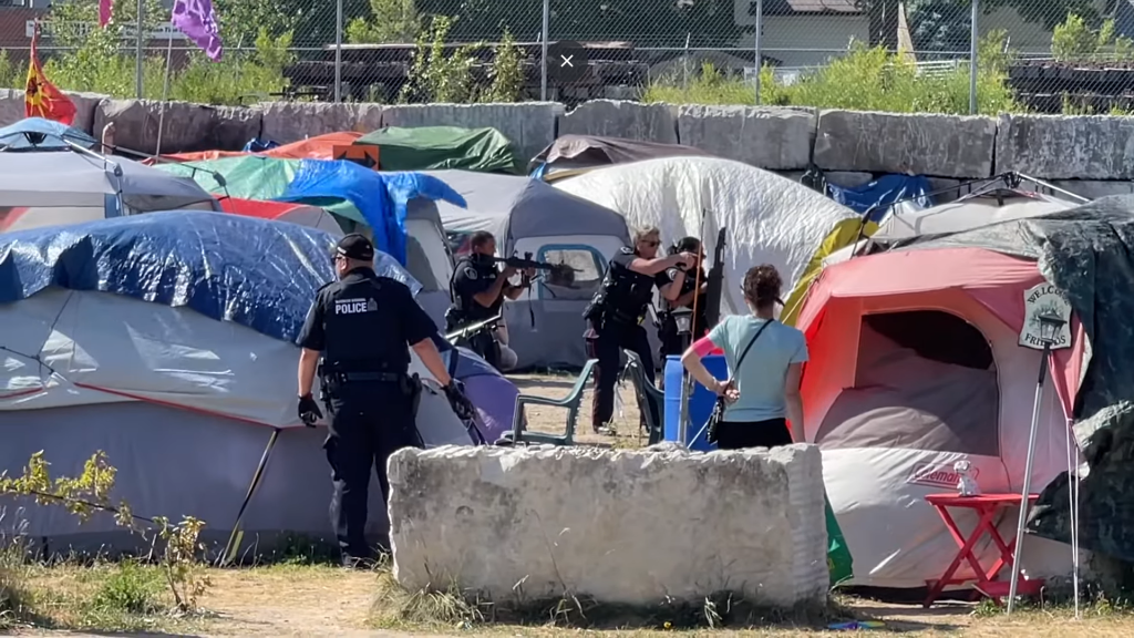 Image of police response to gun call at Kitchener encampment prompts ...